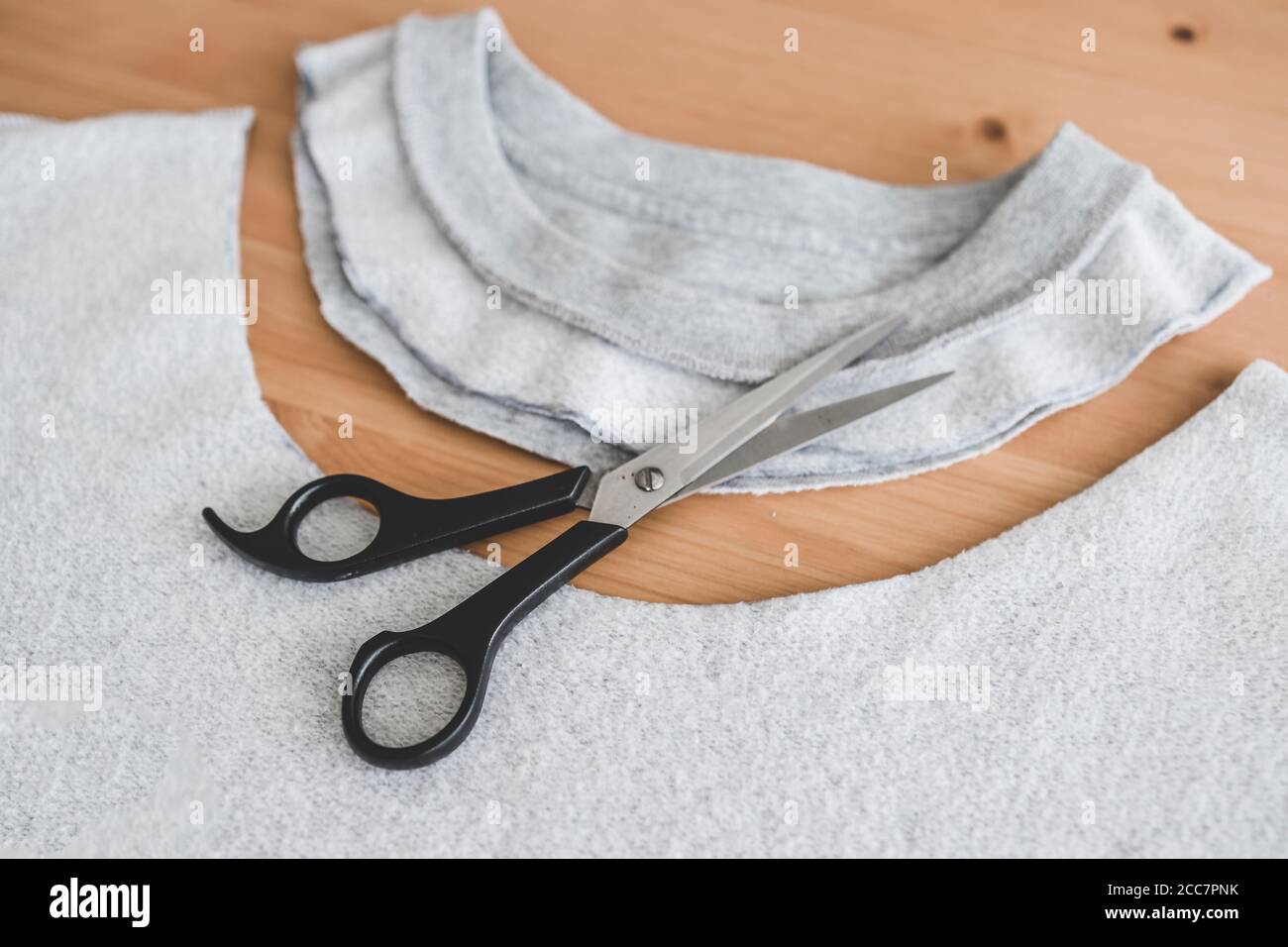 fashion diy and upcycling old clothes concept, sweatshirt with scissors ...