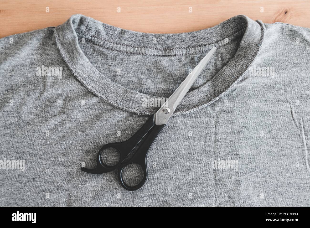 fashion diy and upcycling old clothes concept, t-shirt with scissors to ...