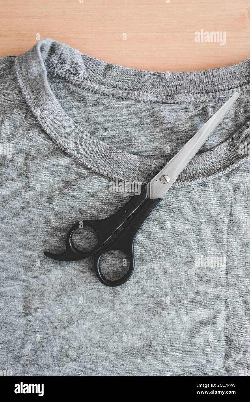 fashion diy and upcycling old clothes concept, t-shirt with scissors to ...