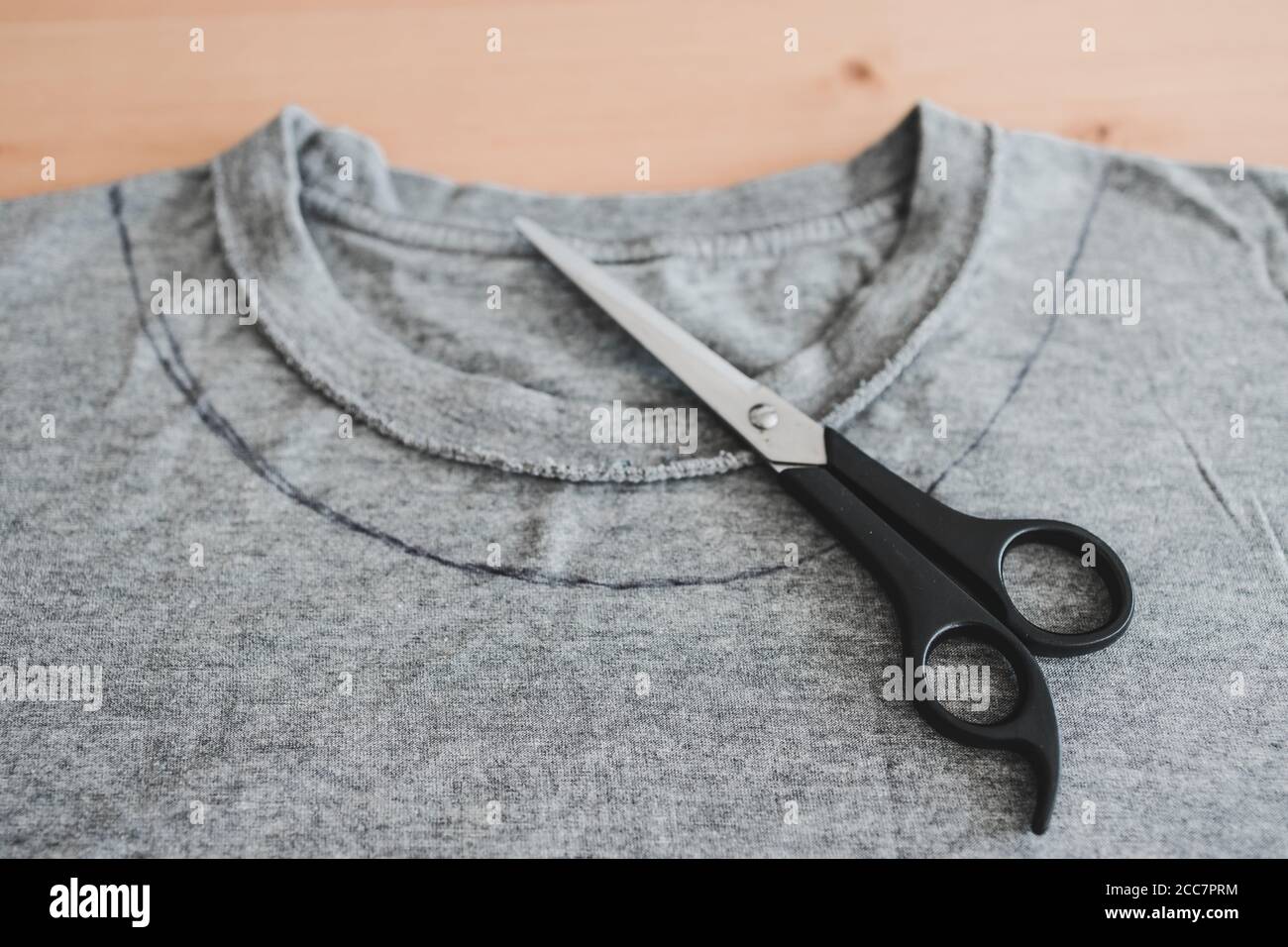 fashion diy and upcycling old clothes concept, t-shirt with scissors to ...