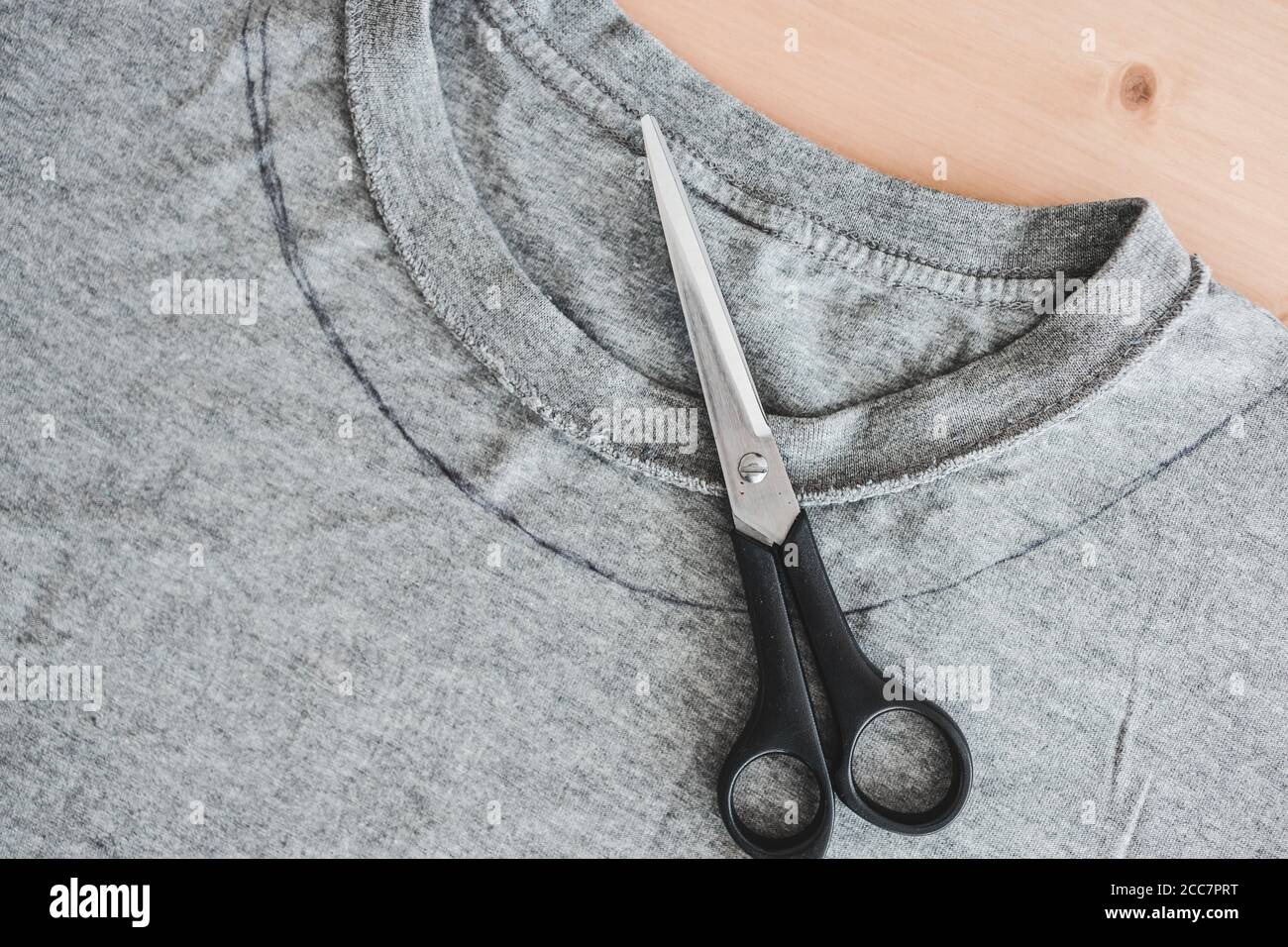 fashion diy and upcycling old clothes concept, t-shirt with scissors to ...