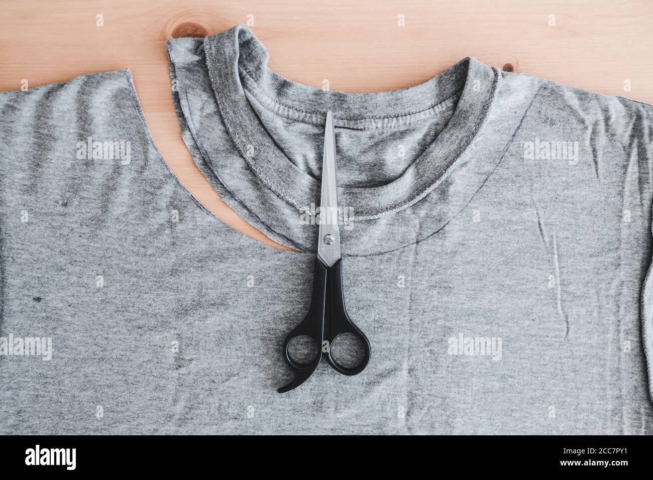 fashion diy and upcycling old clothes concept, t-shirt with scissors to ...