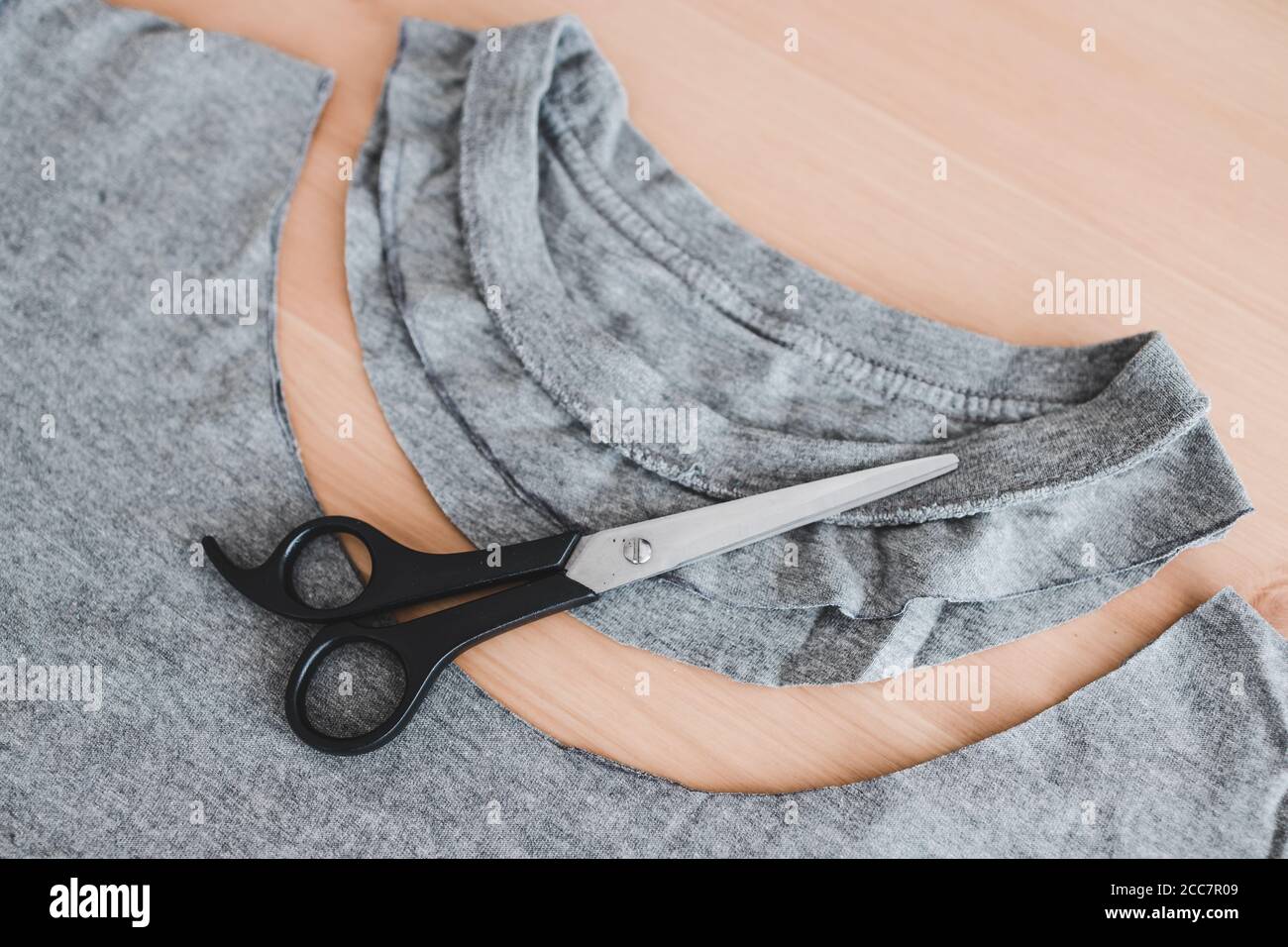 fashion diy and upcycling old clothes concept, t-shirt with scissors to ...
