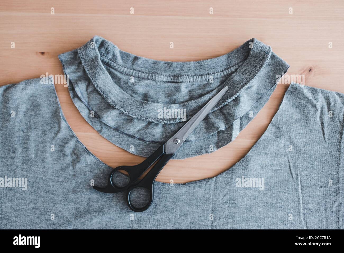 fashion diy and upcycling old clothes concept, t-shirt with scissors to ...