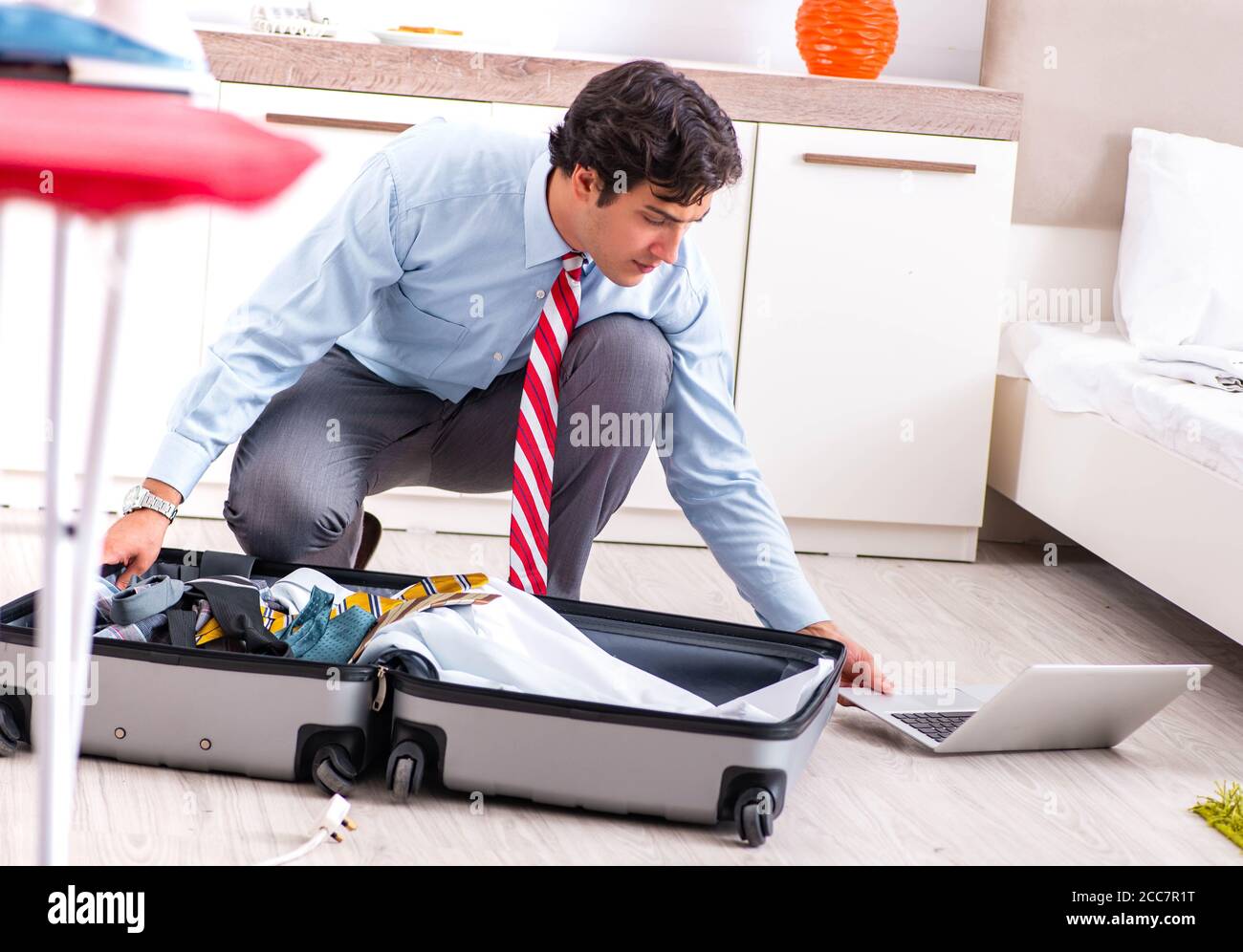 The young handsome businessman preparing for trip Stock Photo - Alamy