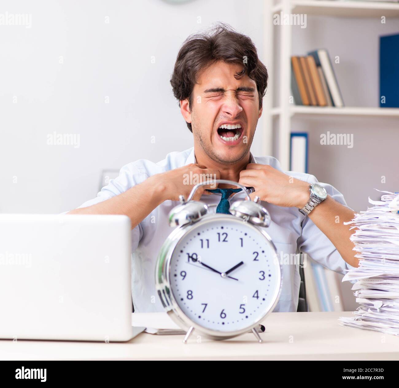 The overloaded busy employee with too much work and paperwork Stock ...