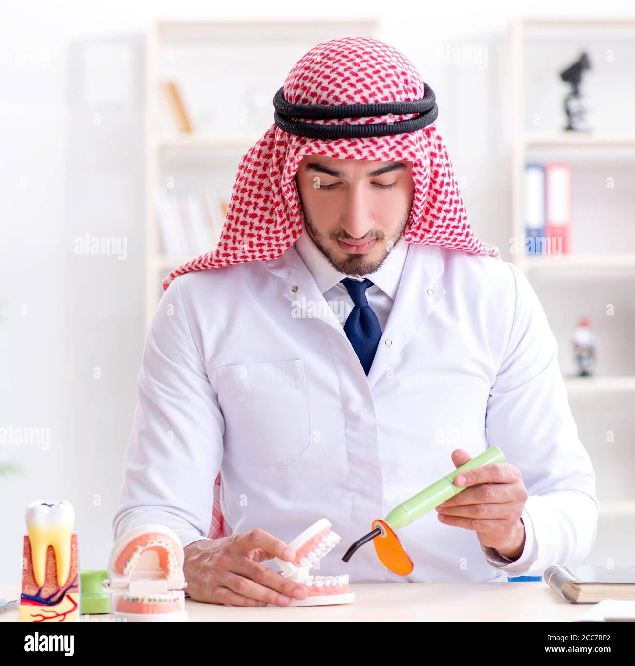 The arab dentist working on new teeth implant Stock Photo - Alamy