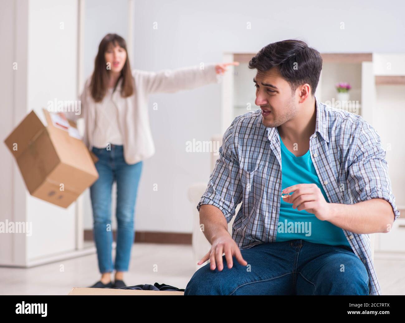 The woman evicting man from house during family conflict Stock Photo ...