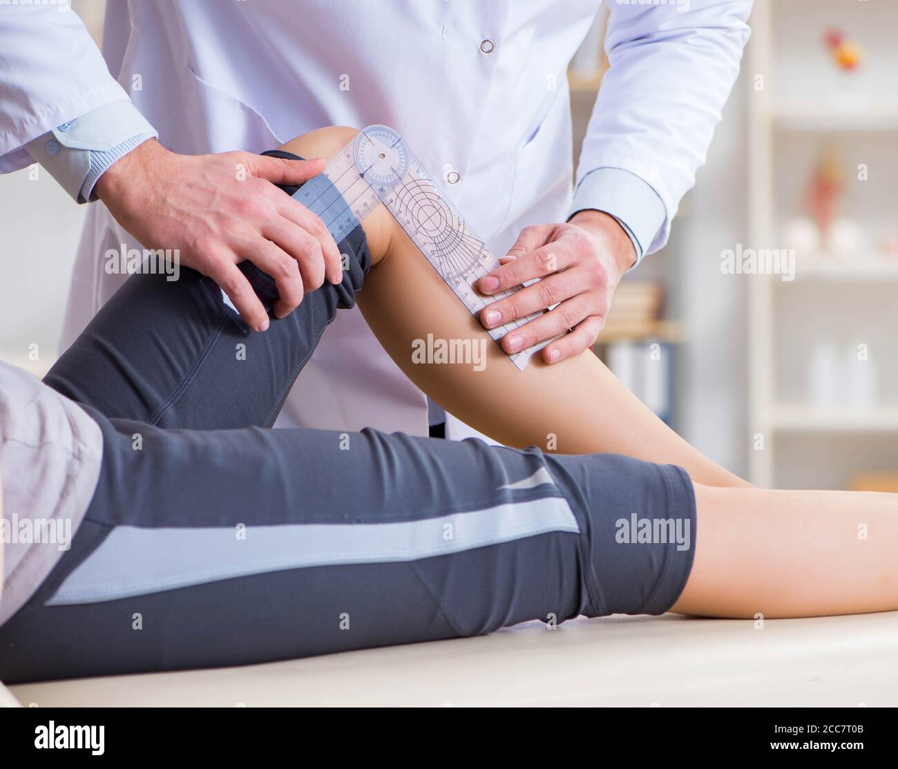 The doctor checking patients joint flexibility Stock Photo - Alamy