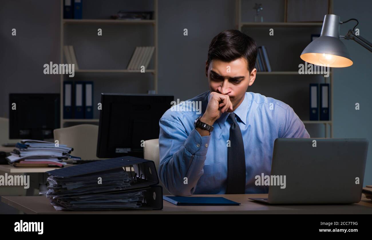 The employee working late at night at important report Stock Photo - Alamy