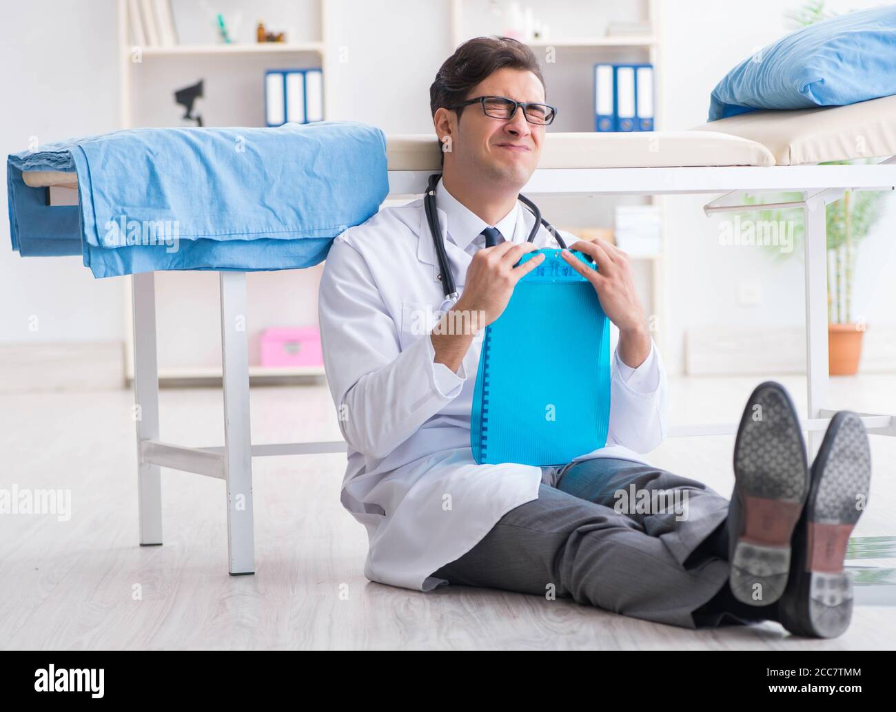 The doctor sitting on the floor in hospital Stock Photo - Alamy