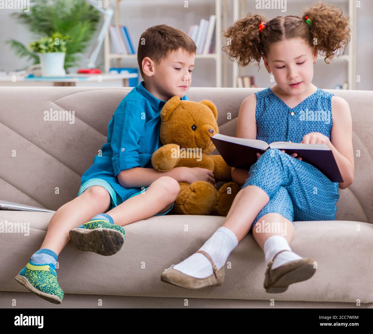The two kids reading books at home Stock Photo - Alamy