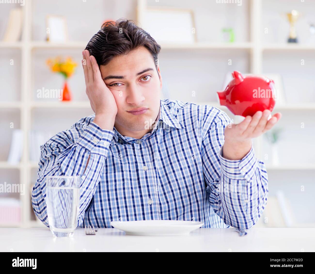 Man running out of money in restaurant and using savings from piggy ...