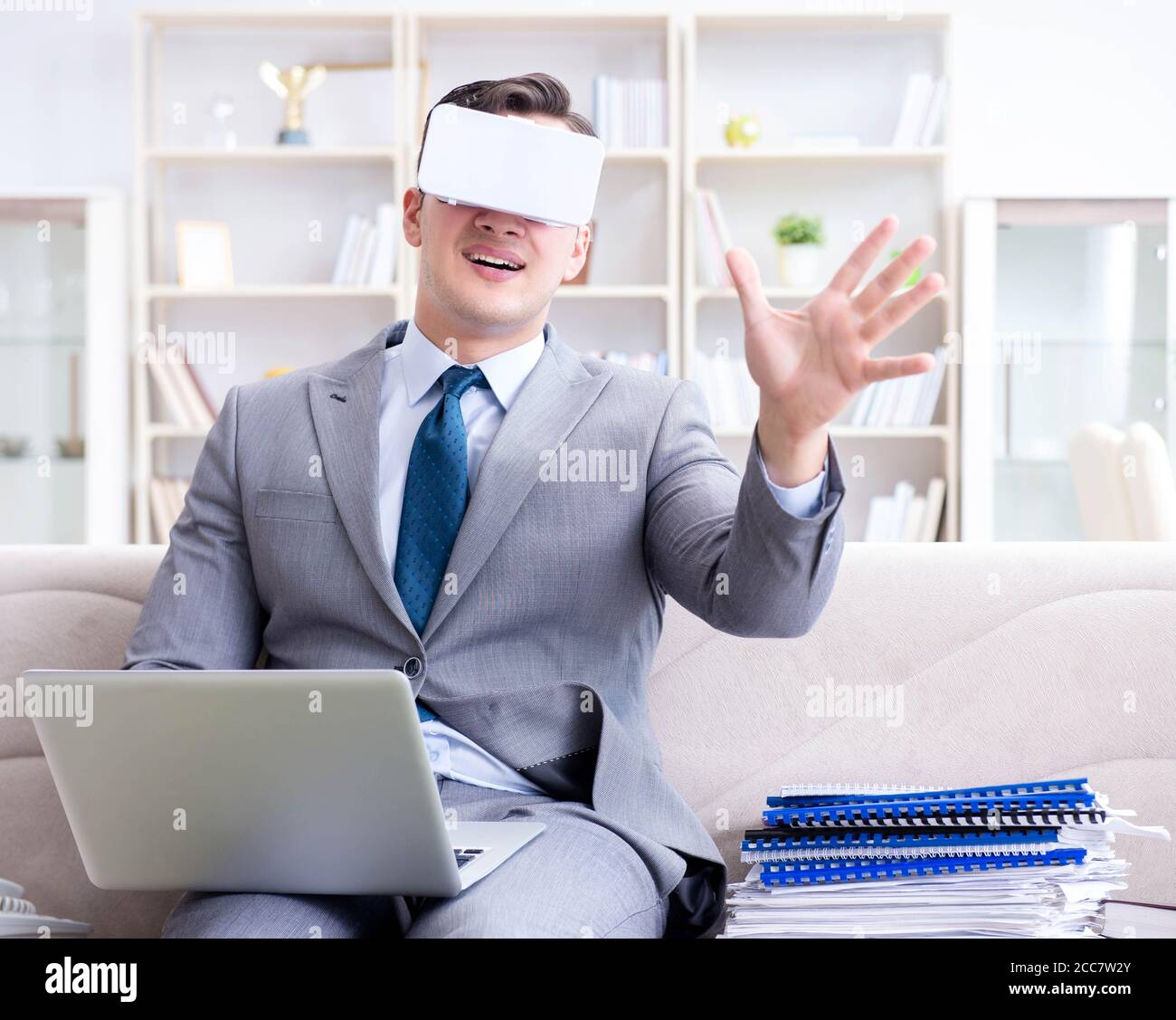 Businessman with virtual reality glasses in modern technology concept ...