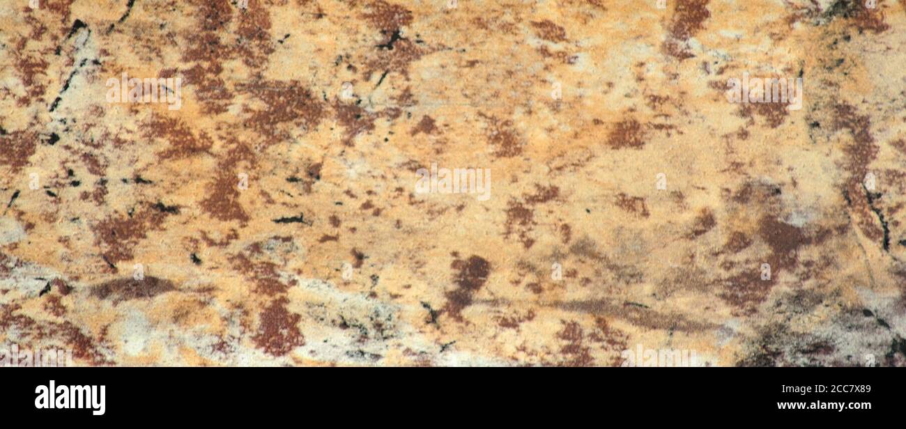Light beige granite with brown inclusions and veins, close-up of ...