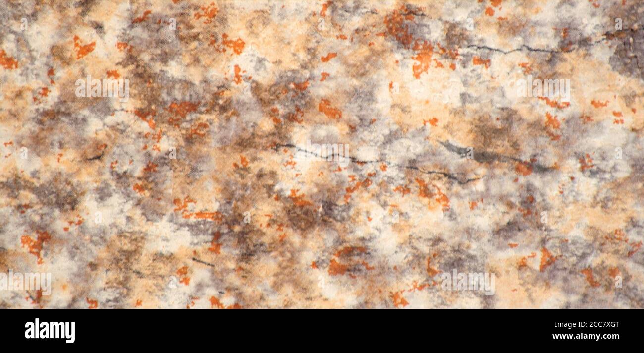 Light beige granite with brown inclusions and veins, close-up of ...