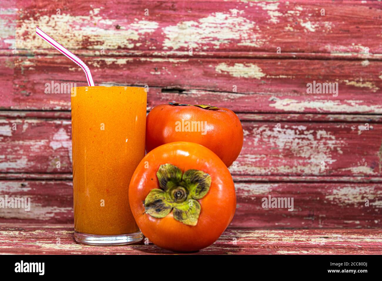 Fruit juice. Persimmon Juice (Diospyros kaki L.)> Aged wood background ...
