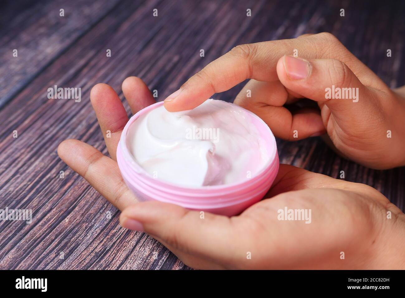 woman applying beauty cream onto skin at home close up Stock Photo - Alamy