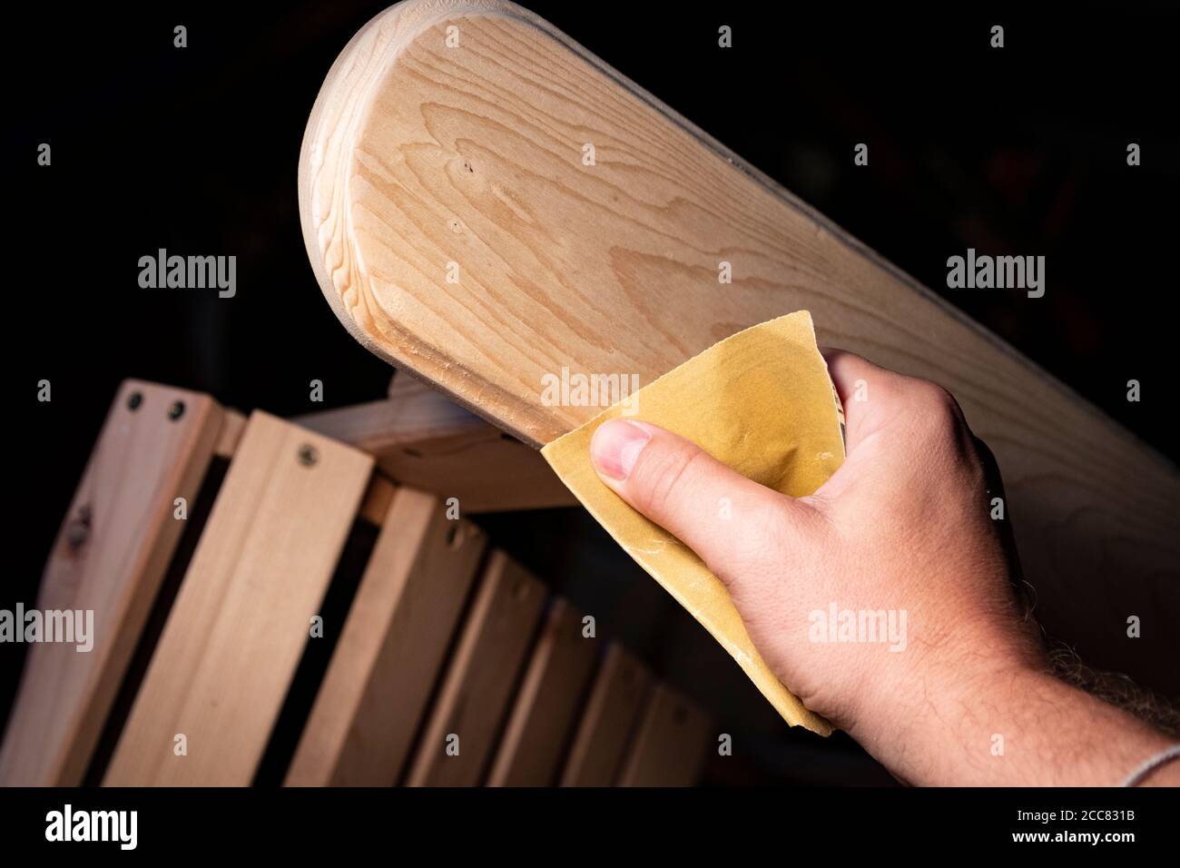 Man's hand sanding wood project with sheet of sandpaper Stock Photo - Alamy