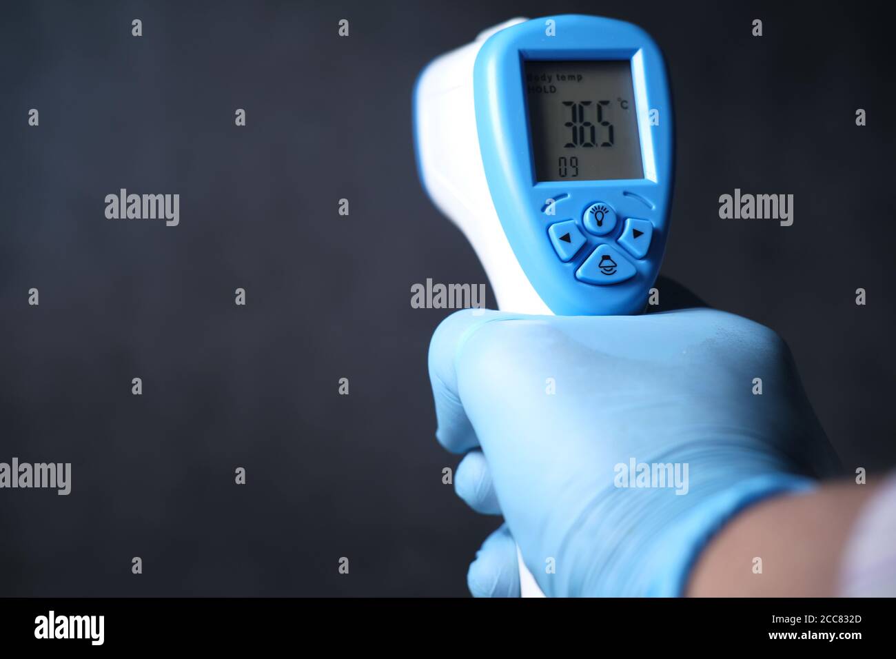 Hand holding infrared thermometer to measuring temperature Stock Photo ...