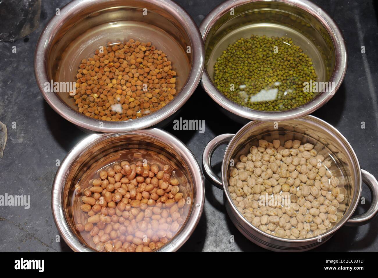 Fresh green gram beans and peanuts with channa on black background ...