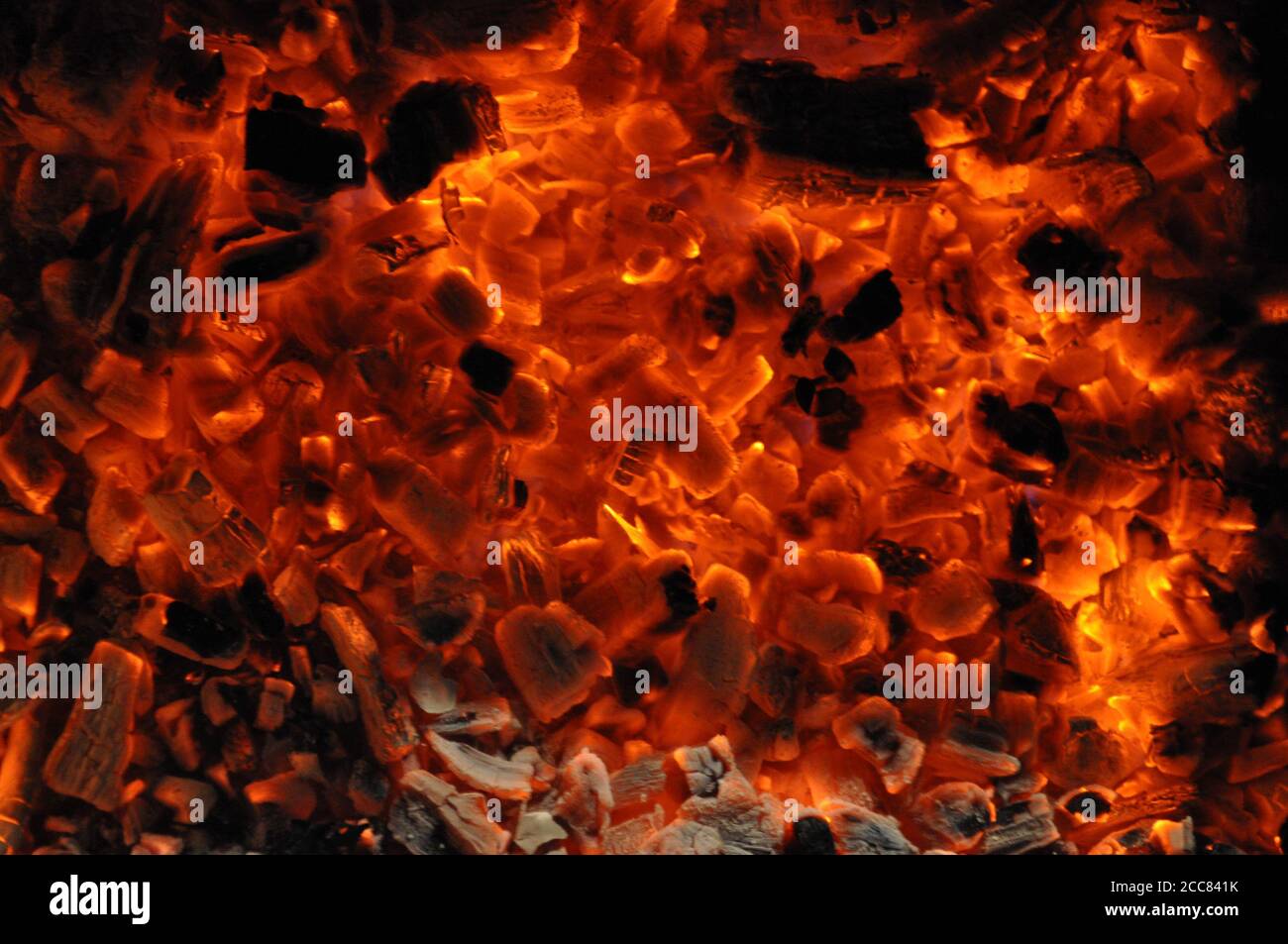 Red flaming texture with smoldering embers of firewood and blazing ...