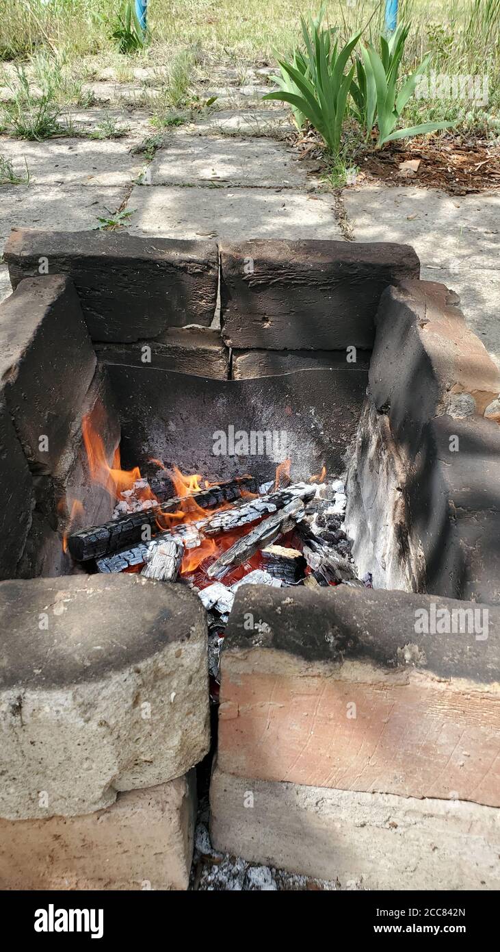 Rustic oven made from cracked burnt red bricks with smoky surface ...