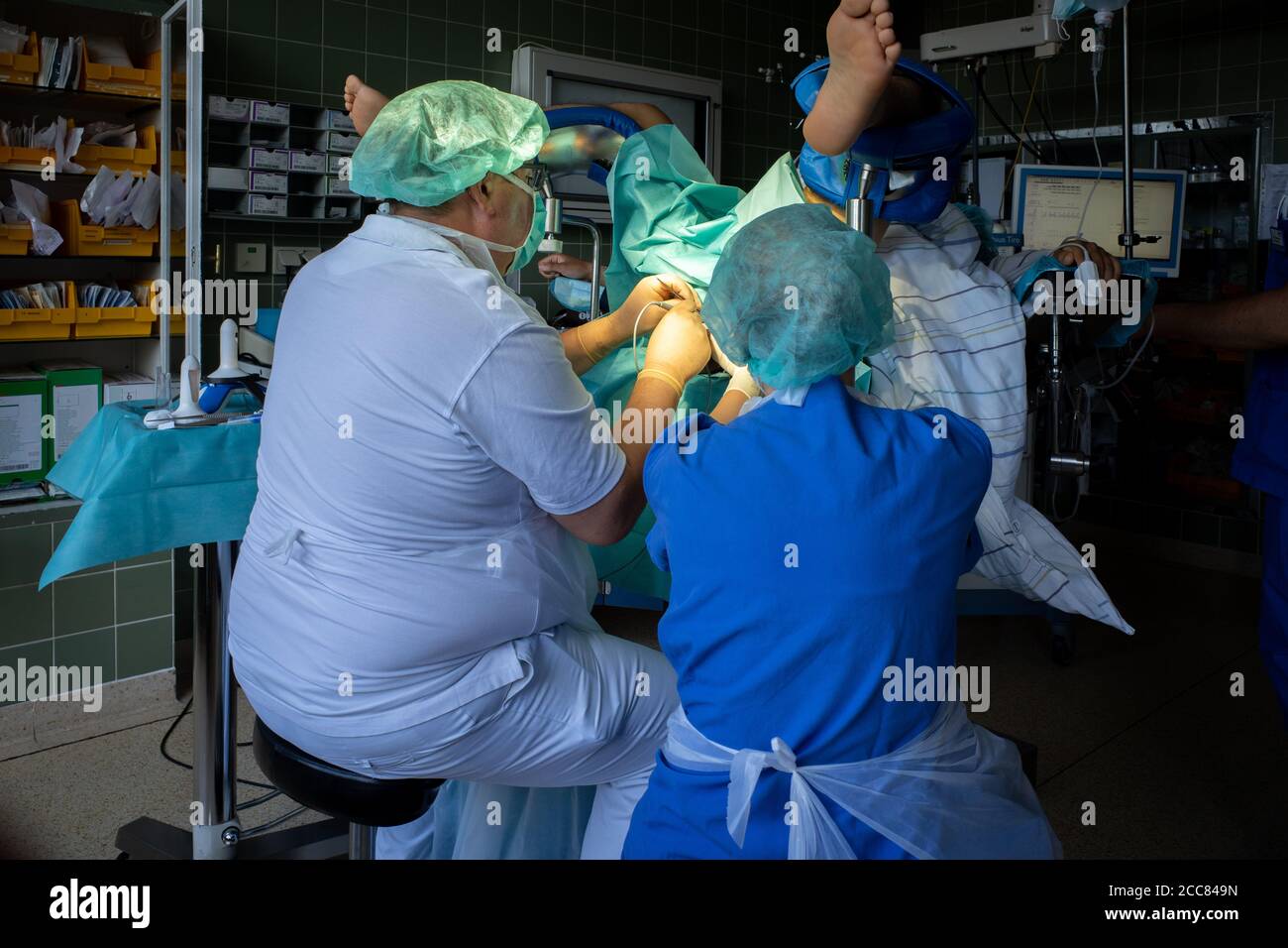 two doctors perform a proctological procedure on one patient Stock ...
