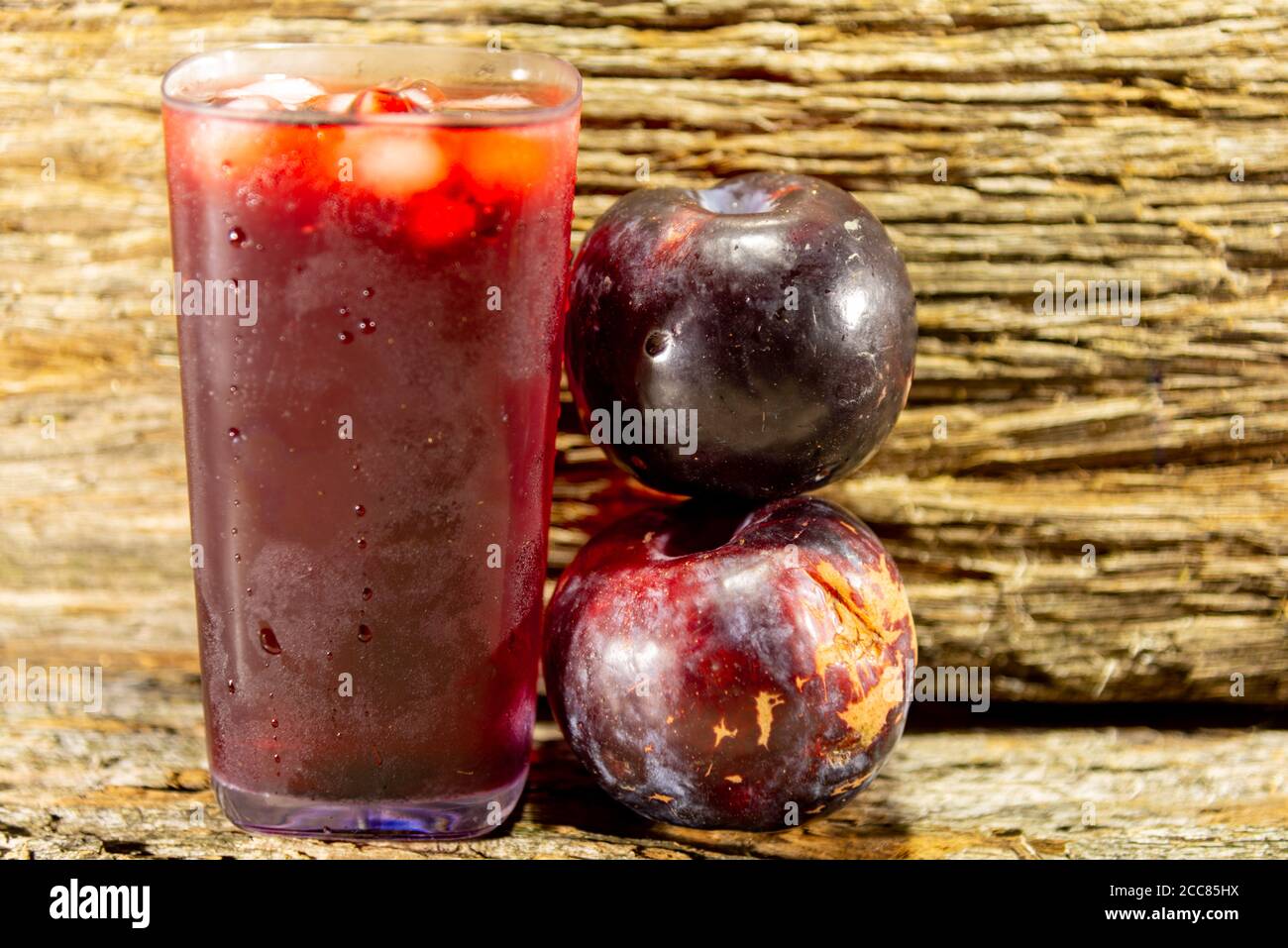 Fruits and plum juice (Prunus domestica). Plum tree, fruit tree of the ...
