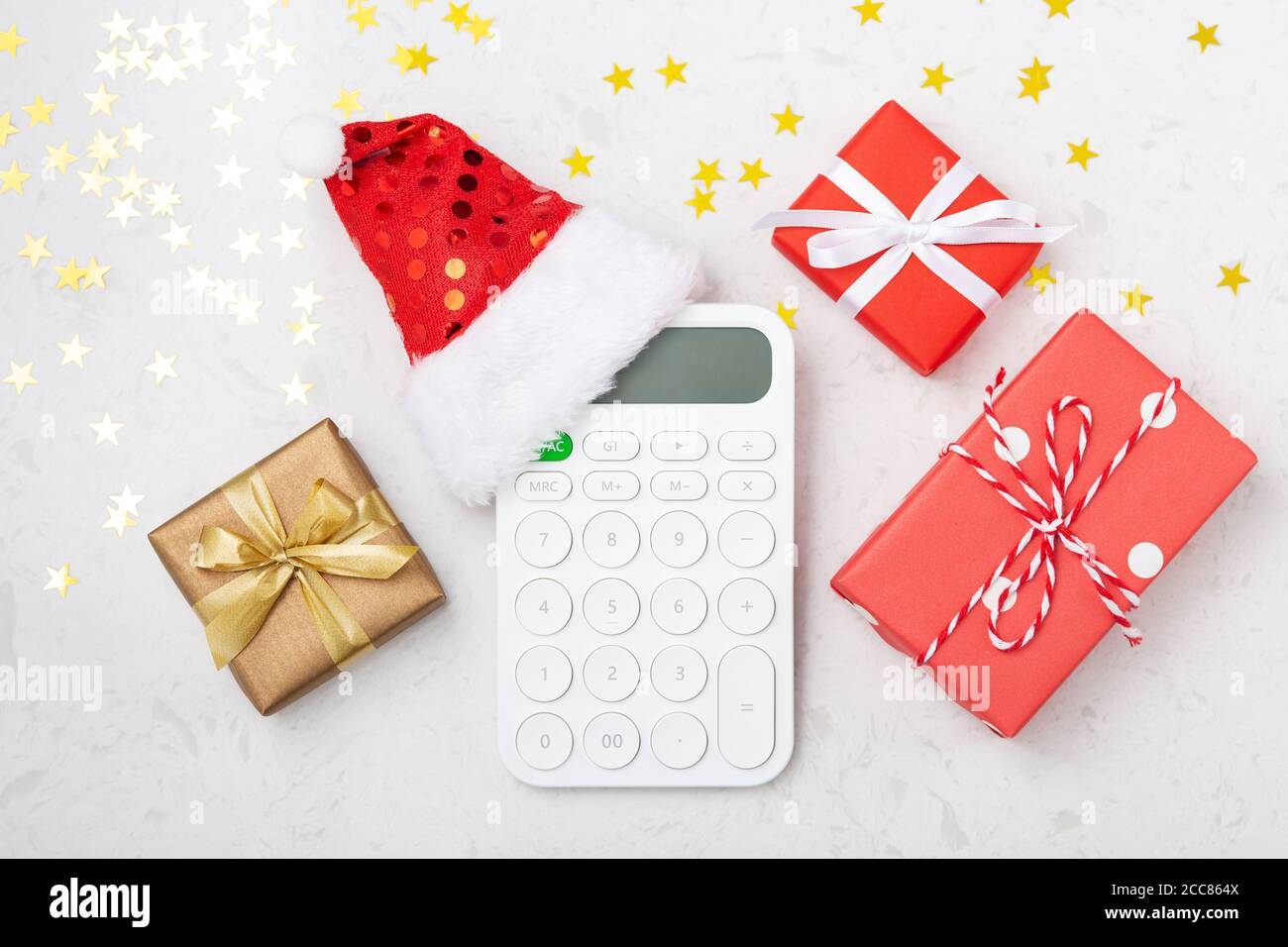 Christmas budget concept with calculator and gift boxes on marble ...