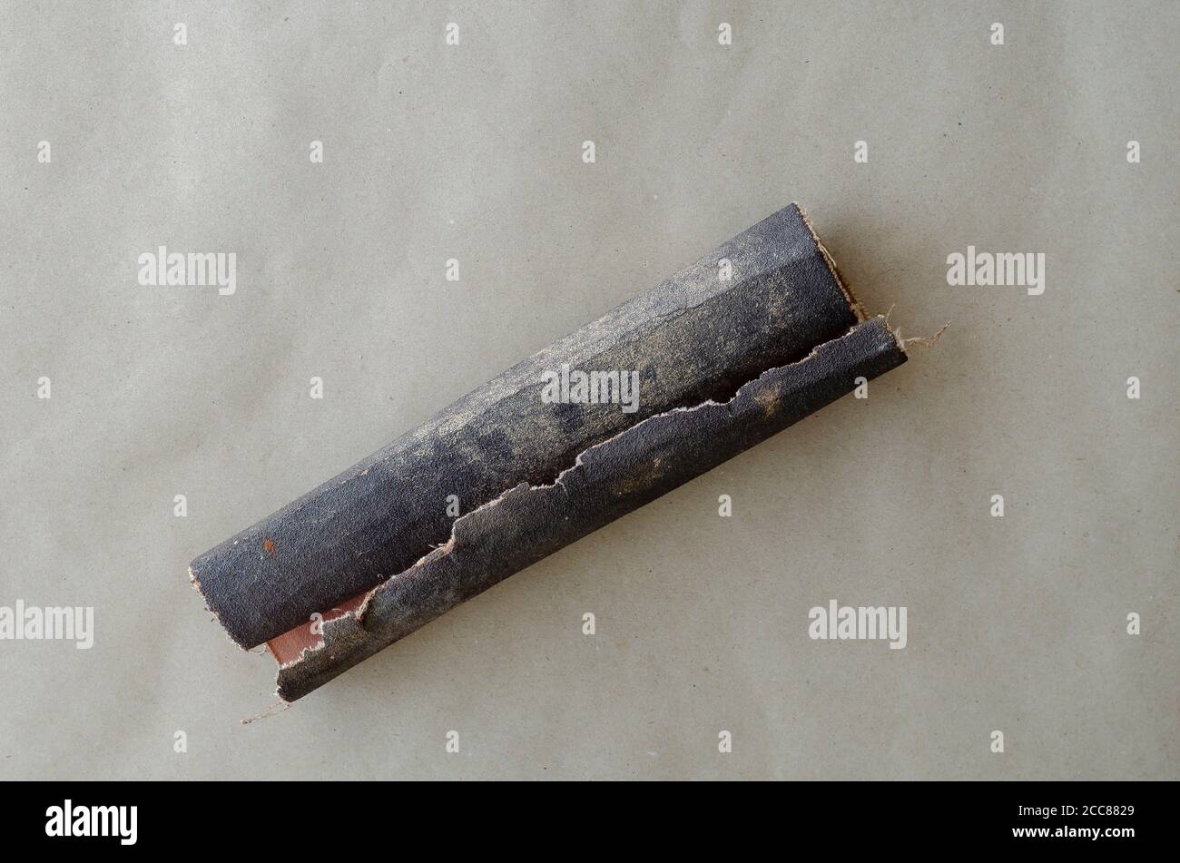 Scroll of old used sandpaper on a beige background. Joinery or ...