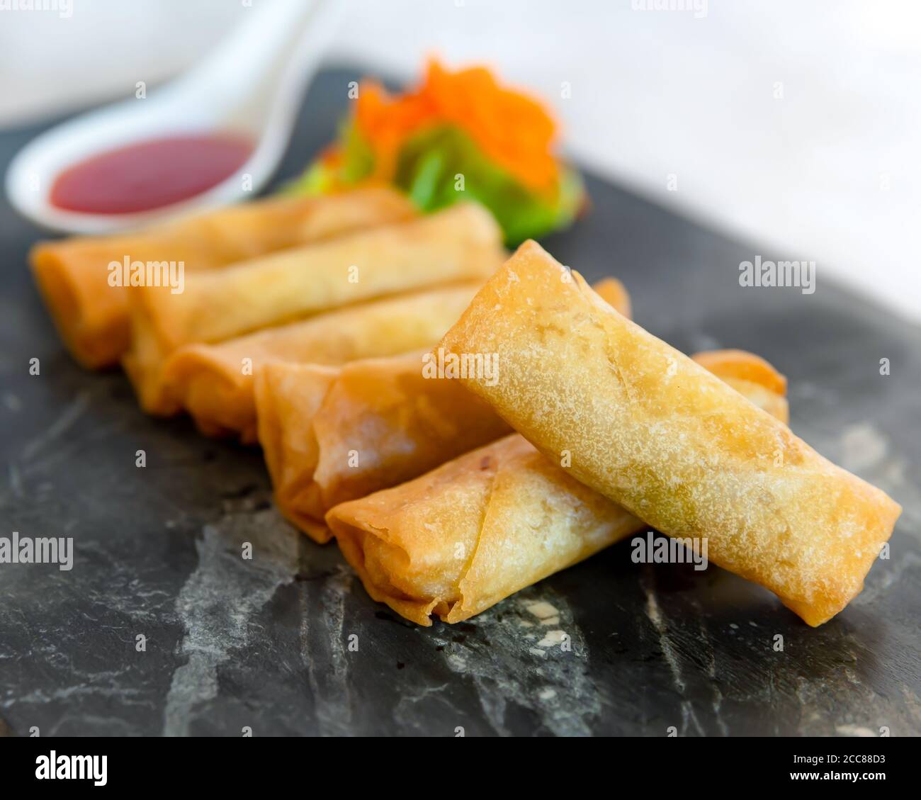 Crispy Vegetarian Spring Rolls on Granite Tray with Sweet Chilli Sauce ...