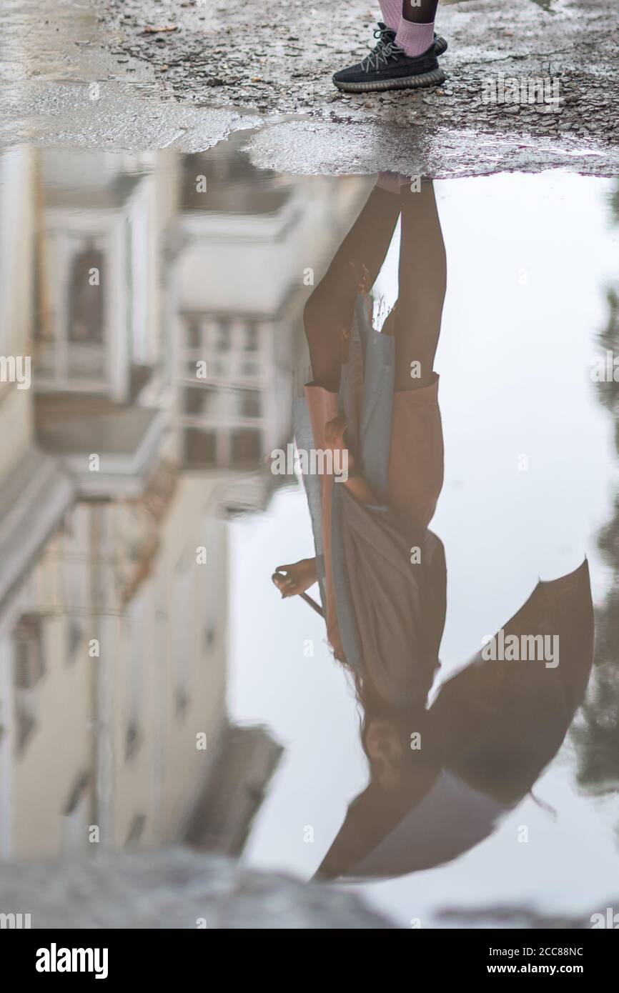 Reflection woman puddle city hi-res stock photography and images - Alamy