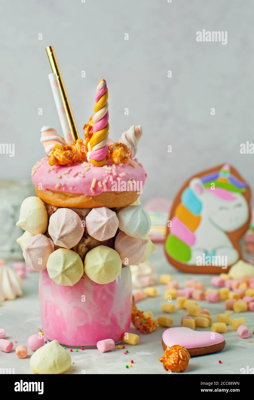 Freak shake topping with donut decorated as unicorn on the grey ...