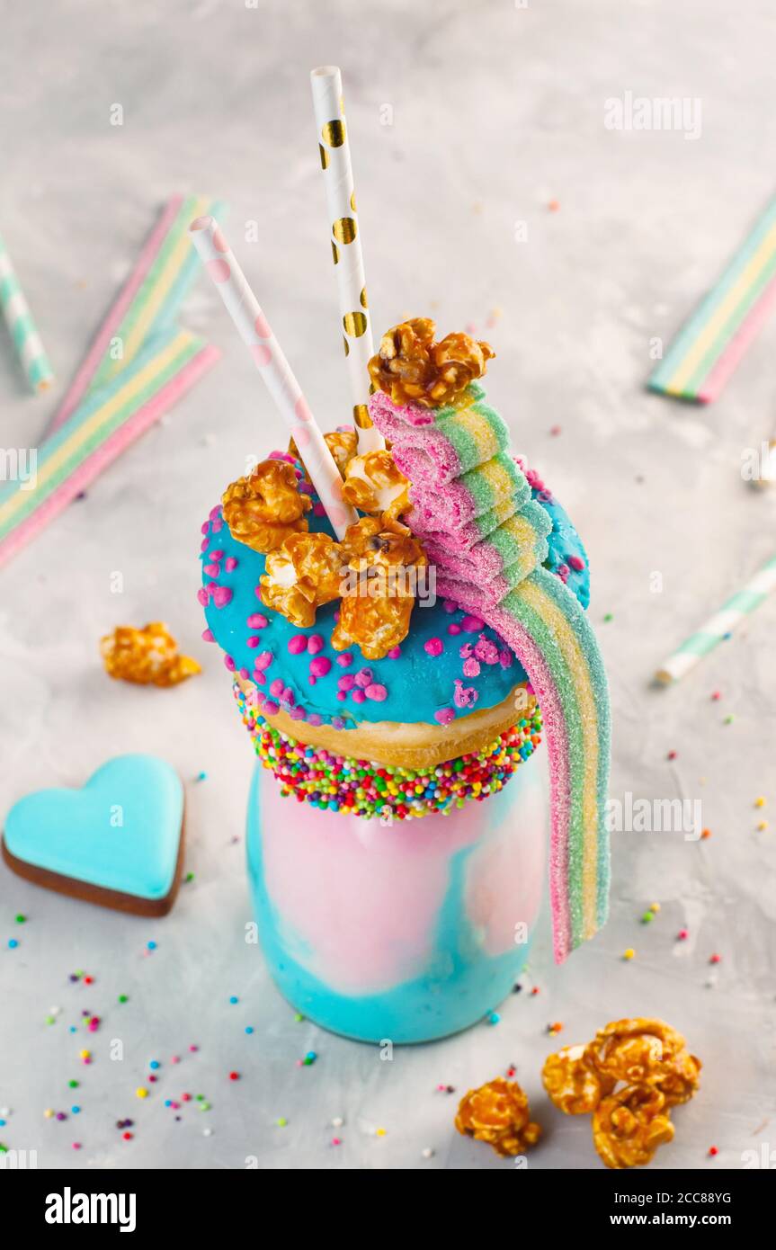 Freak shake topping with donut and marmalade over grey background Stock ...