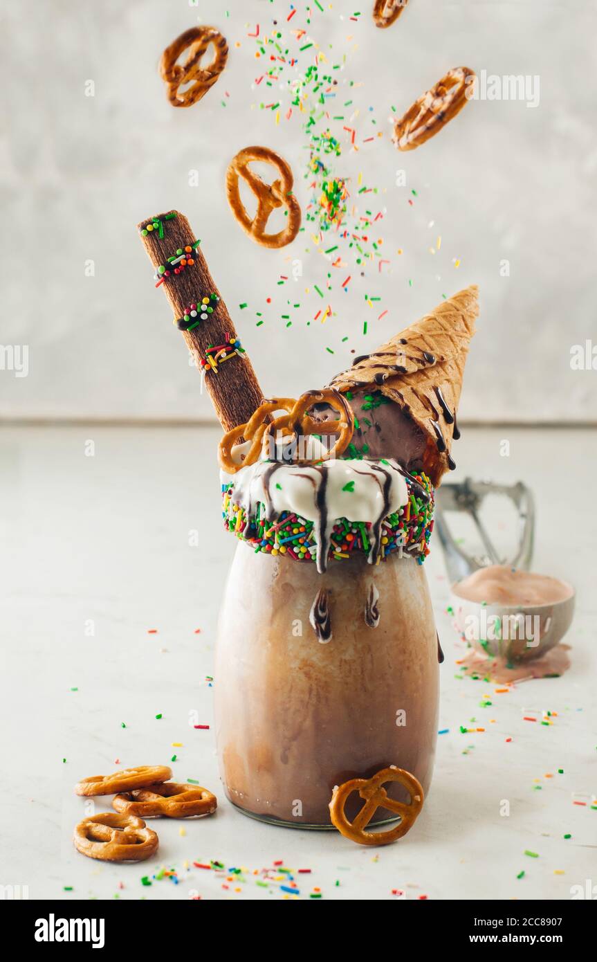 Freak shake with ice cream waffle cone and levitation of ingridients ...