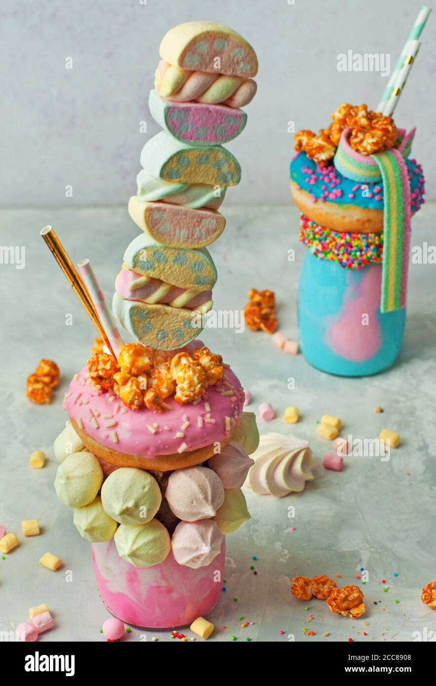 Freak shake topping with donut and marshmallow over grey background ...