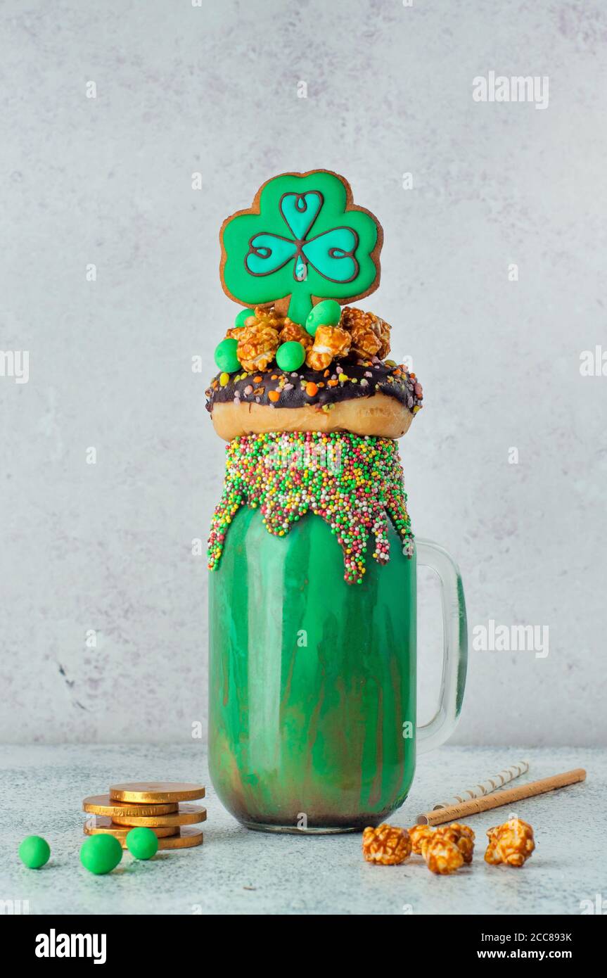 Green freak shake topping with clover cookie on grey background with ...