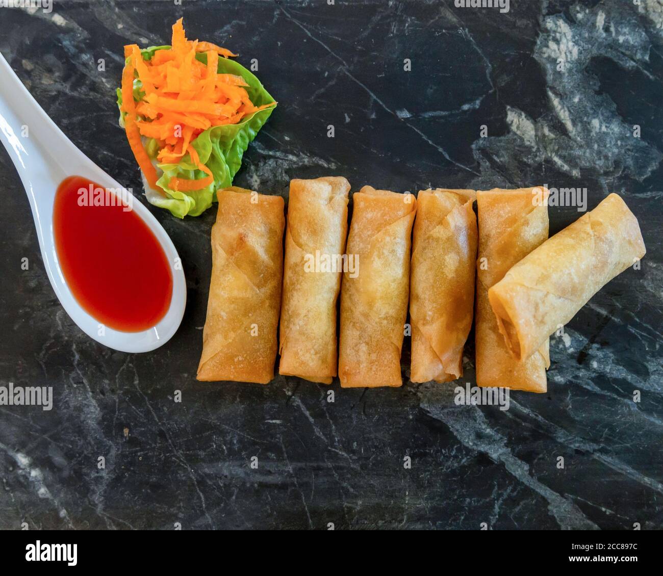 Crispy Vegetarian Spring Rolls on Granite Tray with Sweet Chilli Sauce ...
