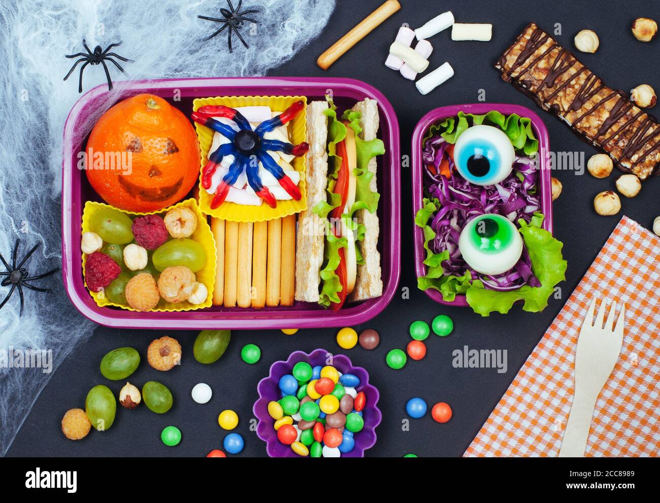 Open Halloween lunch box with sandwich, mandarin, berries and vegetable ...