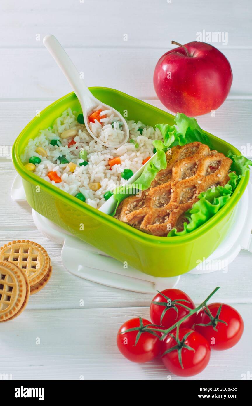 Lunch box with spoon filled with rice and sandwich Stock Photo - Alamy