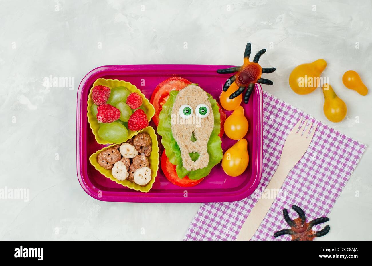 Open Halloween lunch box with school lunch with skull shape sandwich on ...