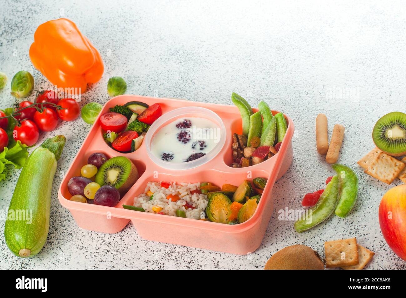 Open lunch box with healthy food on grey background with blank space ...