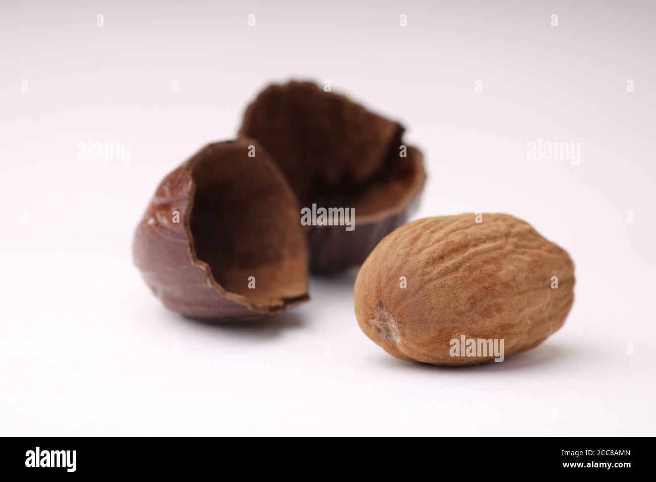 nutmeg spice and its shell isolated on the white background Stock Photo ...