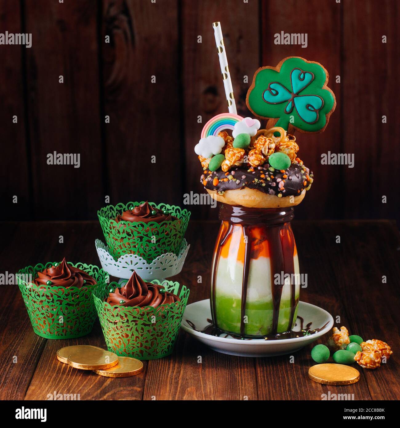 Three color freak shake topping with clover cookie on wooden background ...