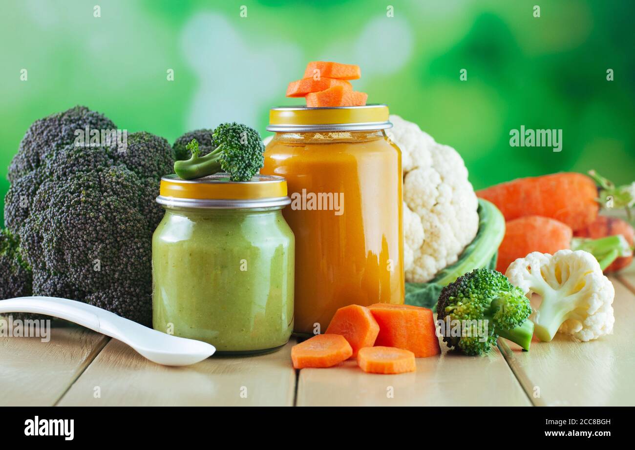 Two jars with vegetable broccoli and carrot puree Stock Photo - Alamy