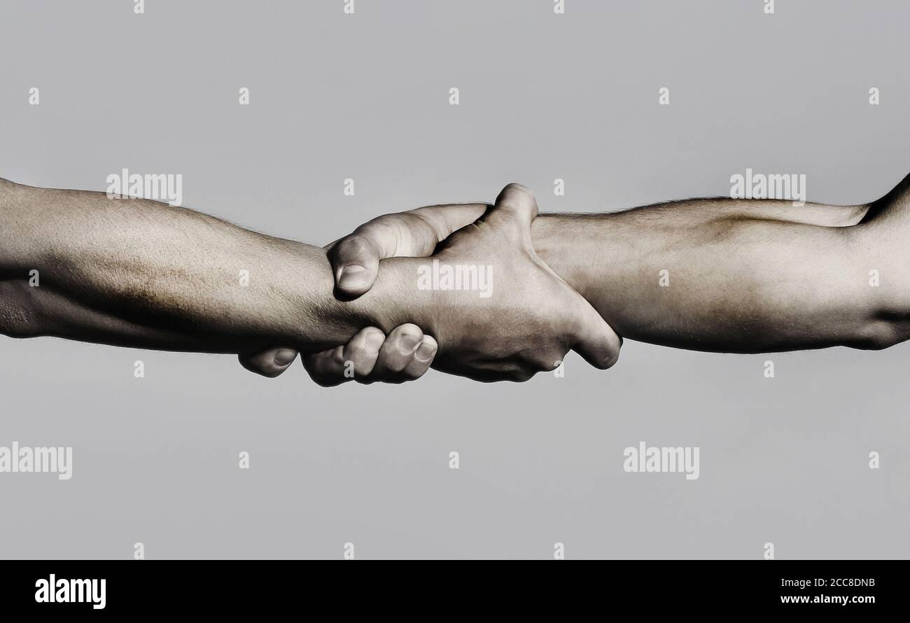 Friendly handshake, friends greeting, teamwork, friendship. Close-up. Rescue, helping gesture or ...