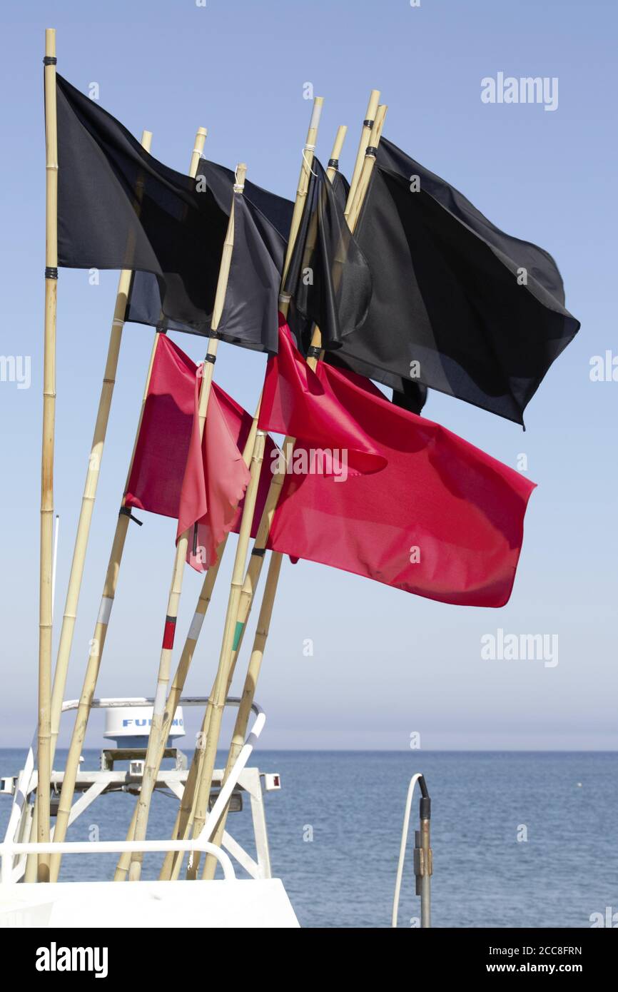 Red and black flags on the boat on the sea in Denmark Stock Photo - Alamy