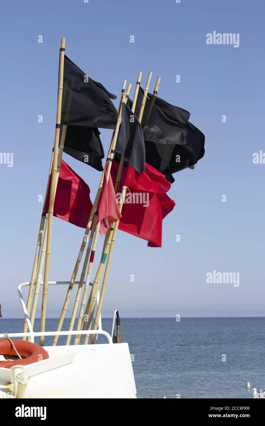 Red and black flags on the boat on the sea in Denmark Stock Photo - Alamy