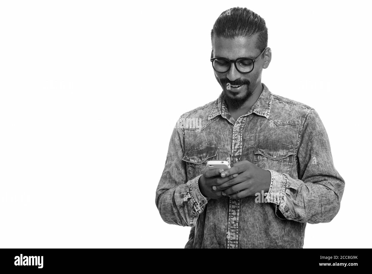 Young happy Indian man using mobile phone Stock Photo - Alamy